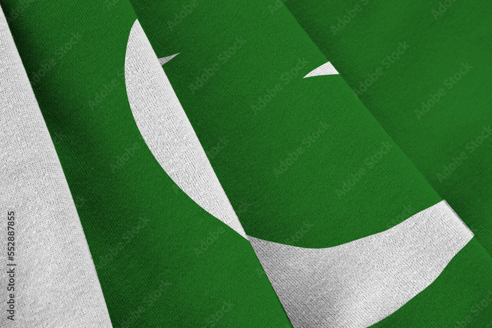 Pakistan flag with big folds waving close up under the studio light ...