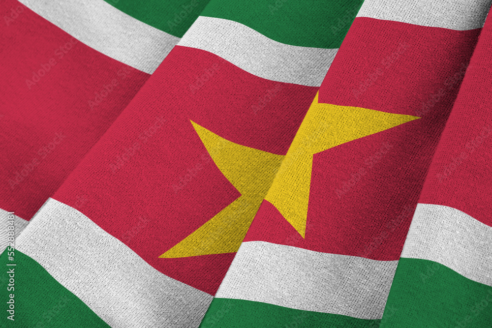 Suriname flag with big folds waving close up under the studio light ...