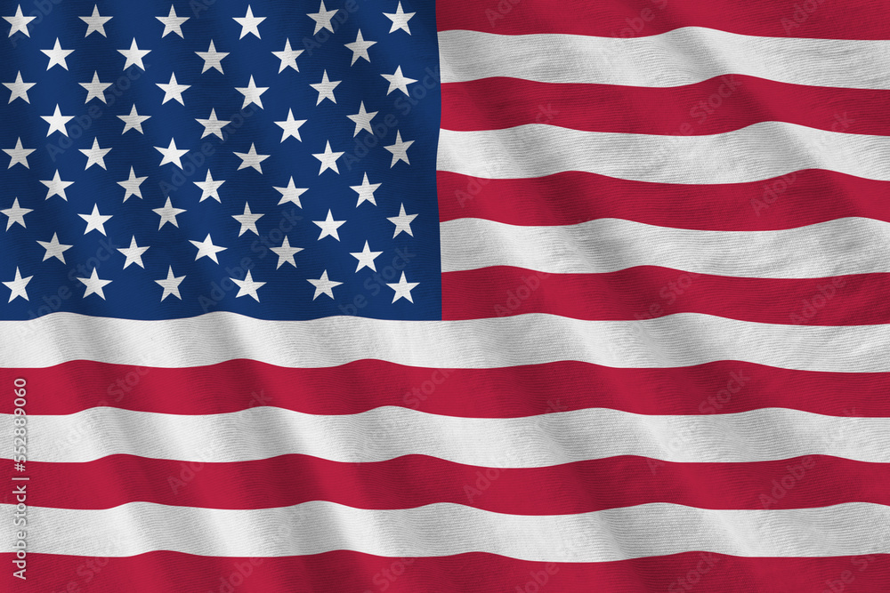 United States of America flag with big folds waving close up under the ...