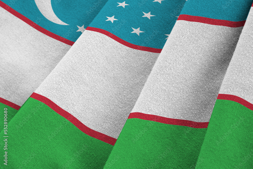 Uzbekistan flag with big folds waving close up under the studio light ...