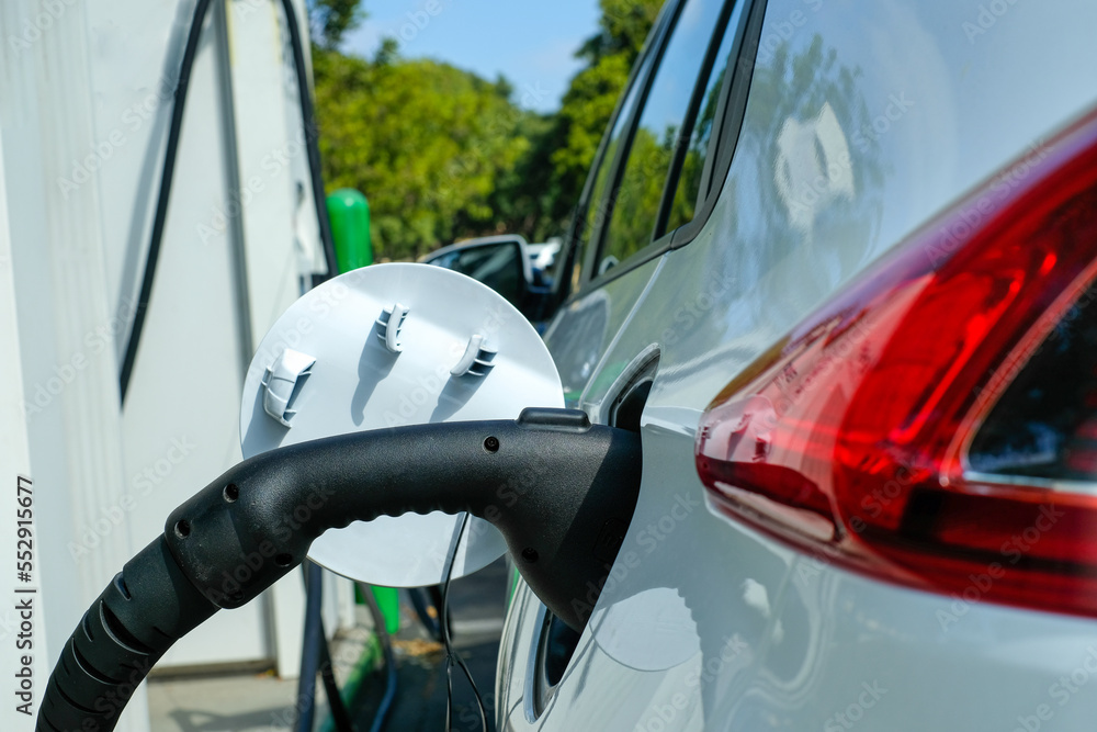 Electric car, EV, plug-in hybrid motor is charging . The eco ...