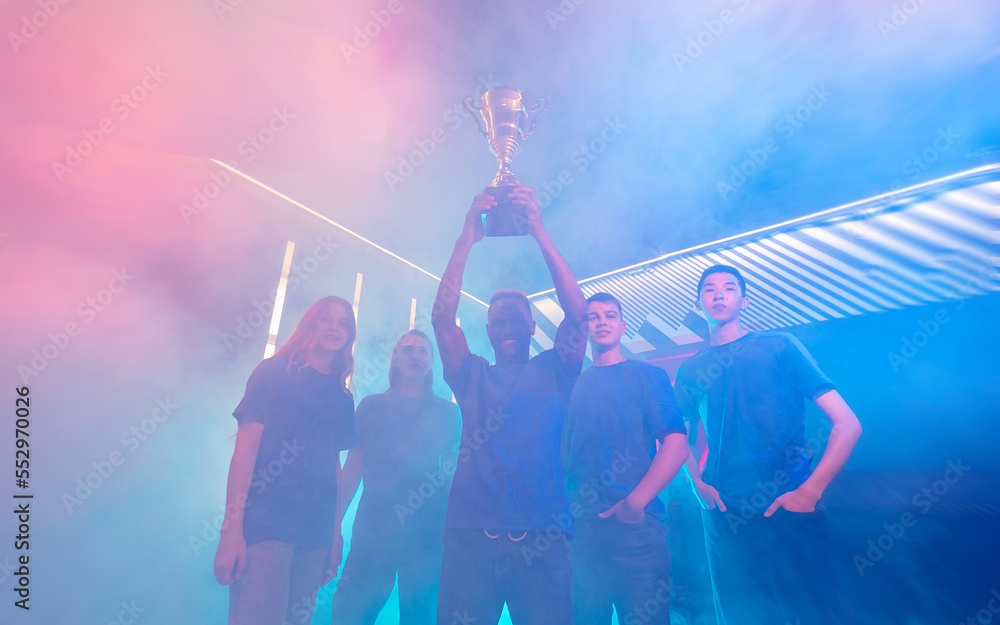 Concept championship cyber gaming esport. Winner team gamer holding cup ...