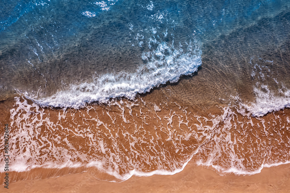 Turquoise water wave with sand beach background from aerial top view ...