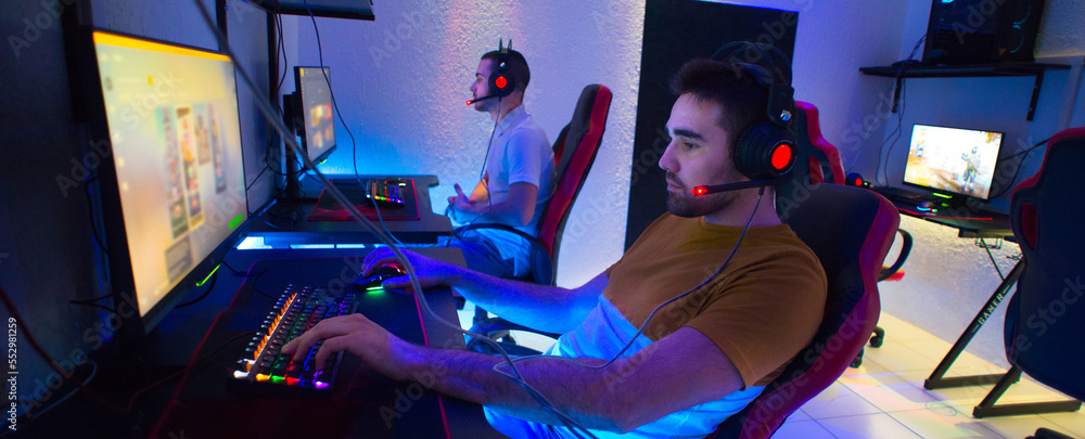 Team of gamers playing computer games at night Stock Photo | Adobe Stock