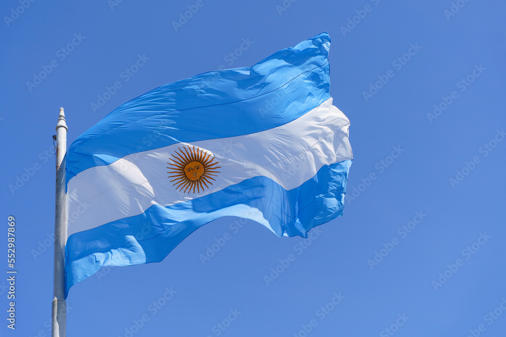 Argentinean flag on a clear blue sky background. Blue and white ...