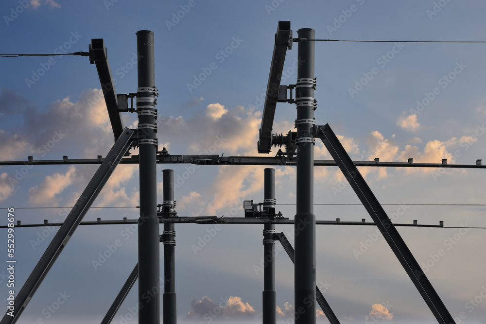 Electric pole, wires and cables on electric tram way with clear sky and ...