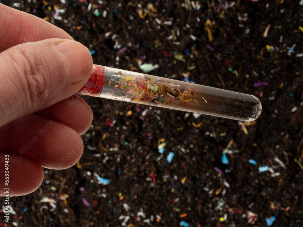 Microplastics in soil a test tube with soil sample - soil contaminated ...