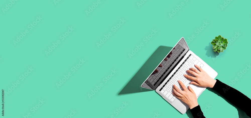 Person using a laptop computer from above Stock Photo | Adobe Stock