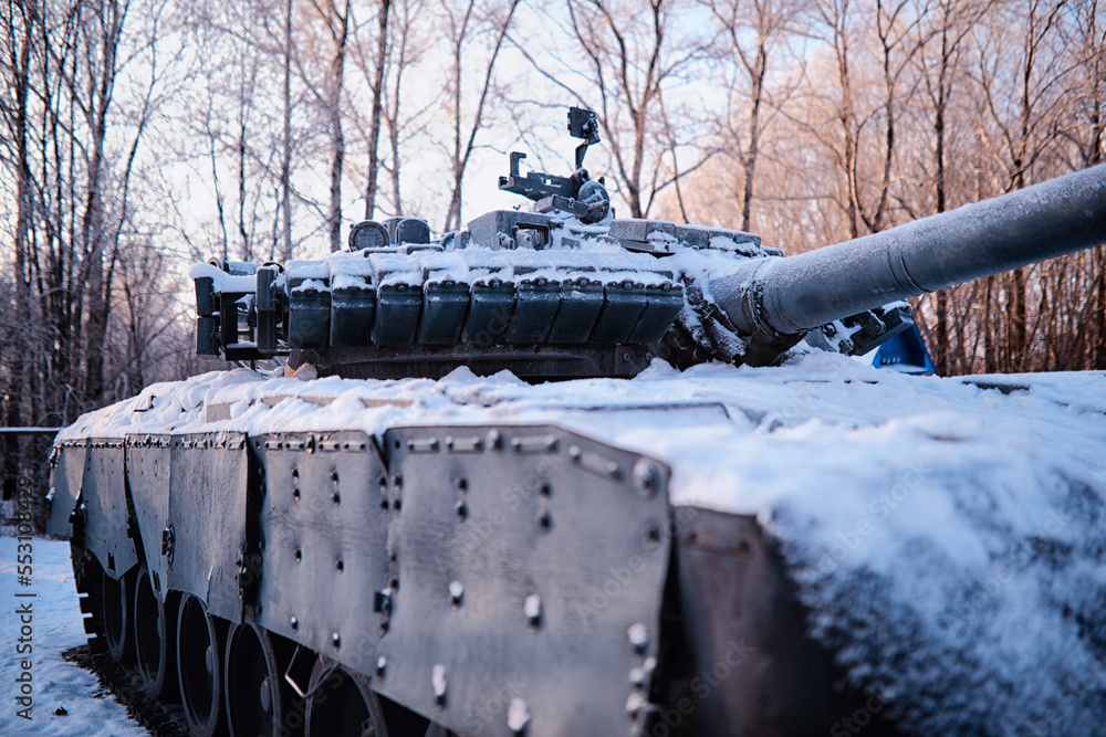 Tank under the snow in the forest. Winter tank camouflage. Battle tank ...