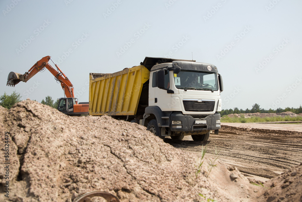 construction dump truck with a yellow body and an orange crawler ...