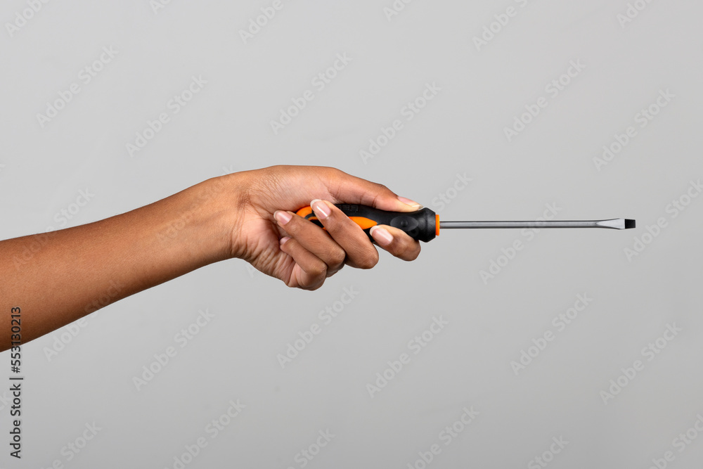 Black female hand showing screwdriver Stock Photo | Adobe Stock