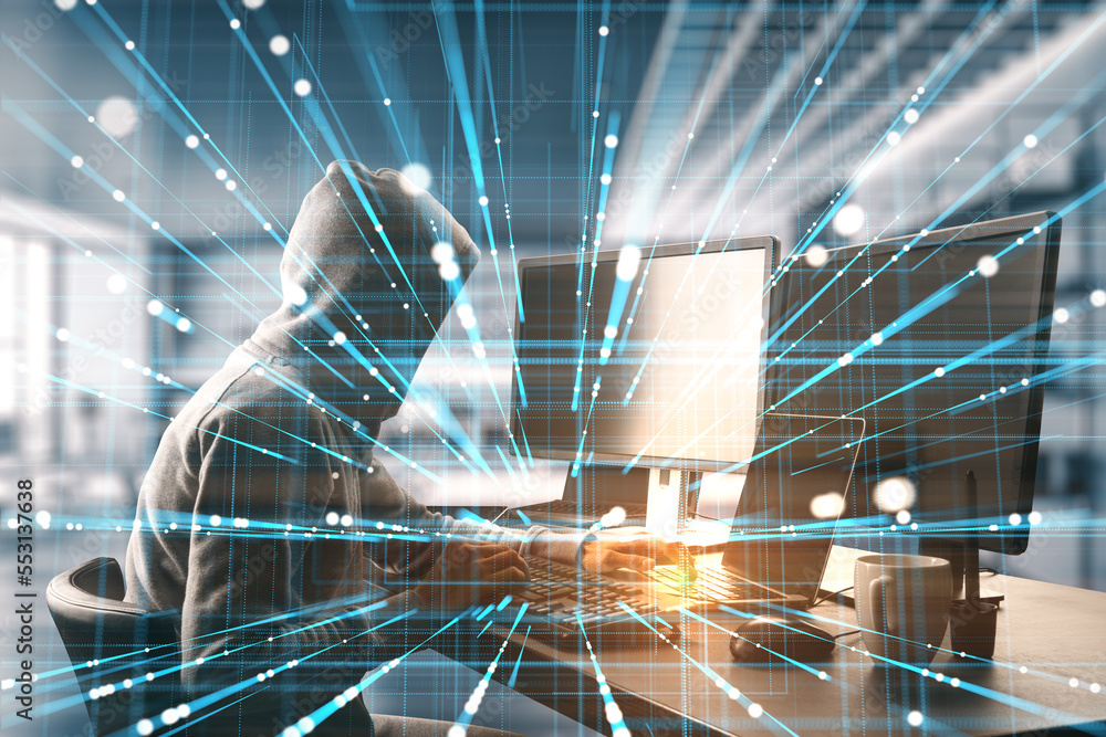 hacker using laptop at table with creative linear matrix hologram on ...