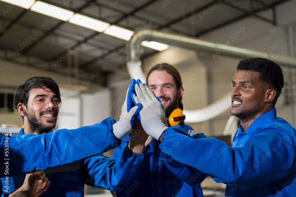 Group of male technician workers working and holding hands together in ...