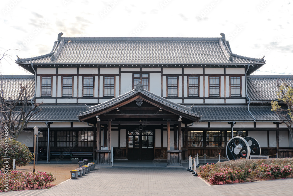 Former Nijo Station building with a wheel set exhibit in front in Kyoto ...