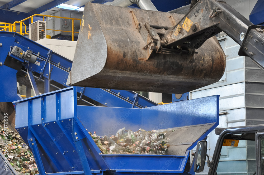 waste sorting center, excavator loading trash in a waste recycling ...