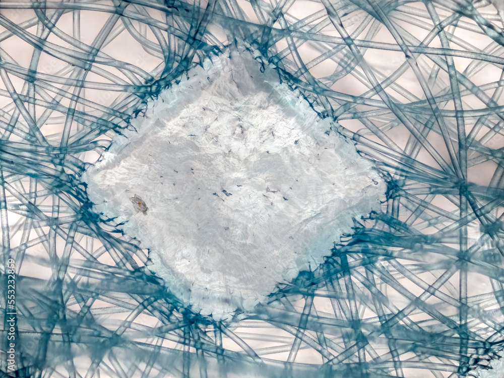 microstructure of a surgical mask under the microscope - optical ...