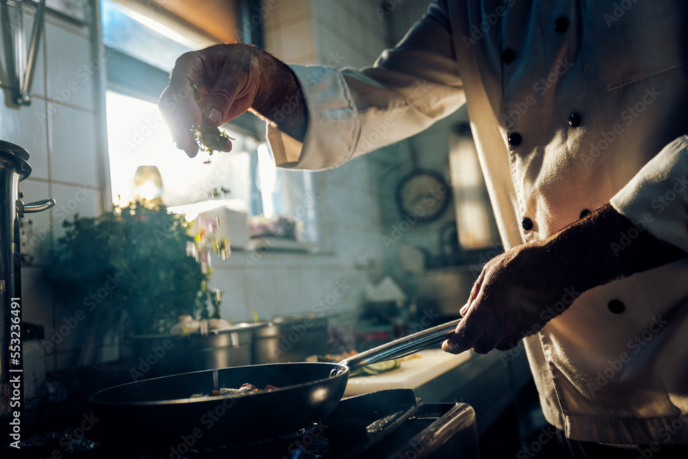 Chef cooking in a commercial kitchen. Stock Photo | Adobe Stock