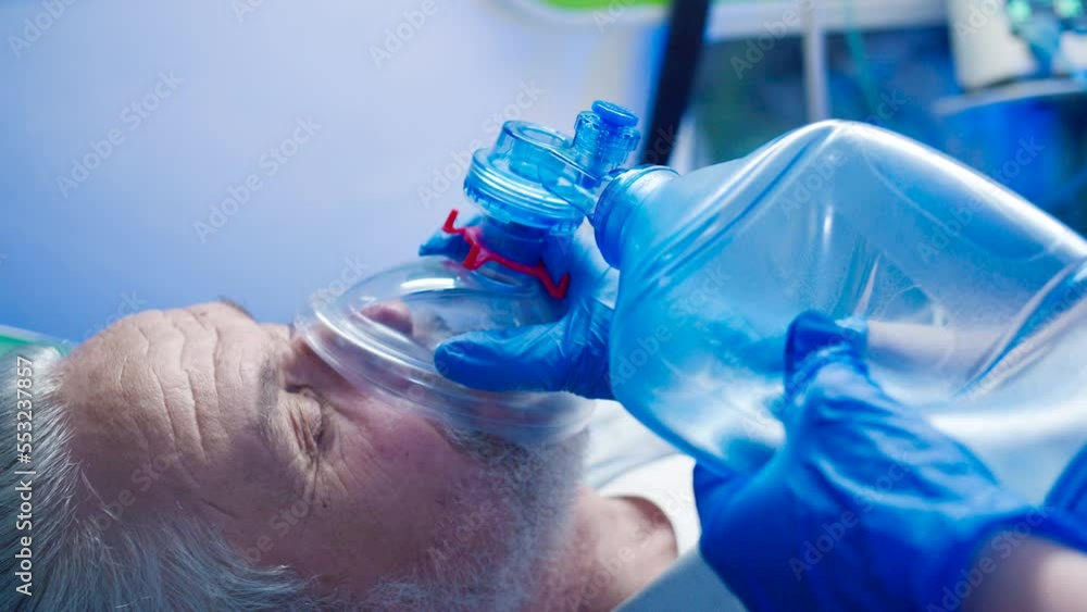 Close-up of senior grey-haired mature man lying on stretchers inside of ...