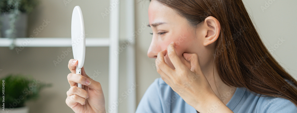 Dermatology, itchy asian young woman, girl looking at mirror ...