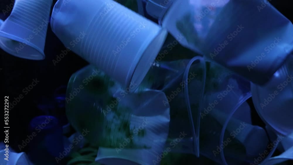 problem of global plastic pollution. white plastic cups float in blue ...