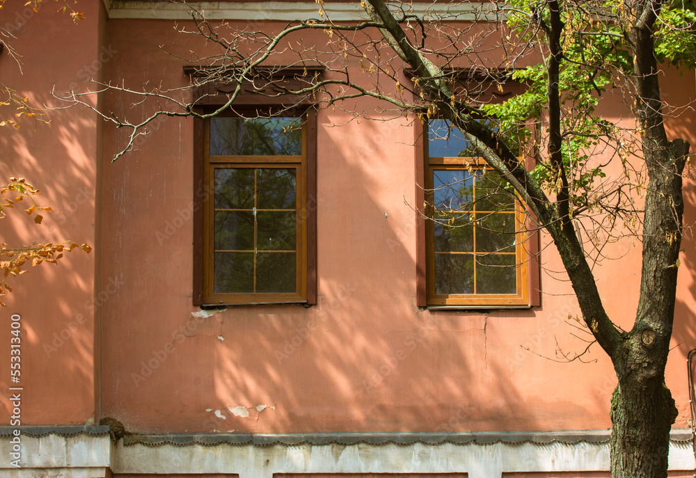 Orange building wall, old apartment house facade with wooden window ...