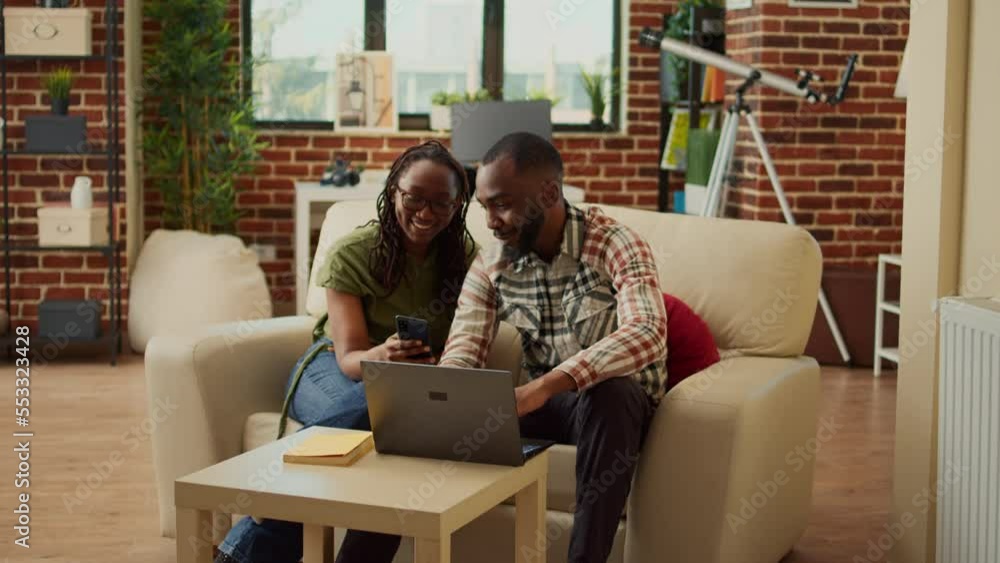 African american people relaxing at home on sofa, scrolling through ...