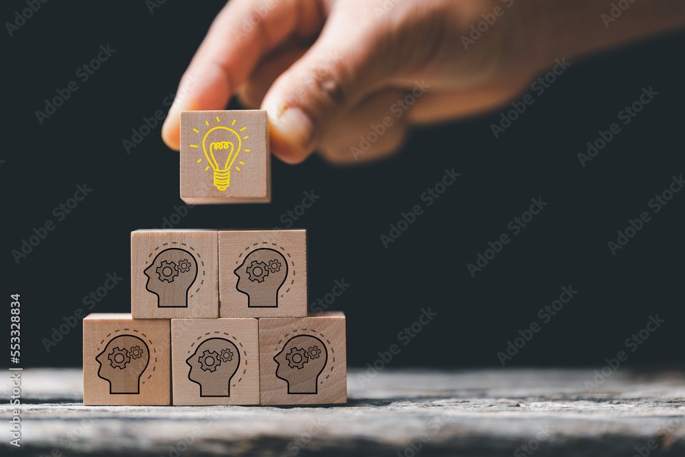 Concept creative idea and innovation. Hand choose wooden cube block ...