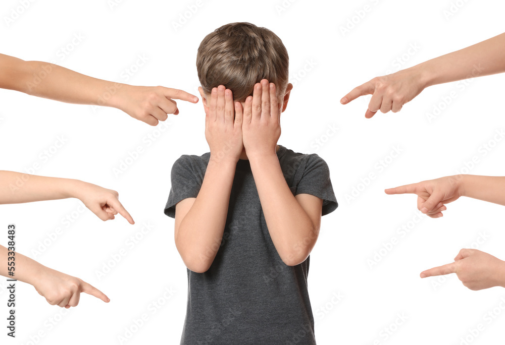 Boy covering face with hands and kids pointing at him on white ...
