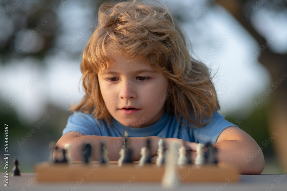 Boy and chess, closeup portrait. Early development. Child thinking ...