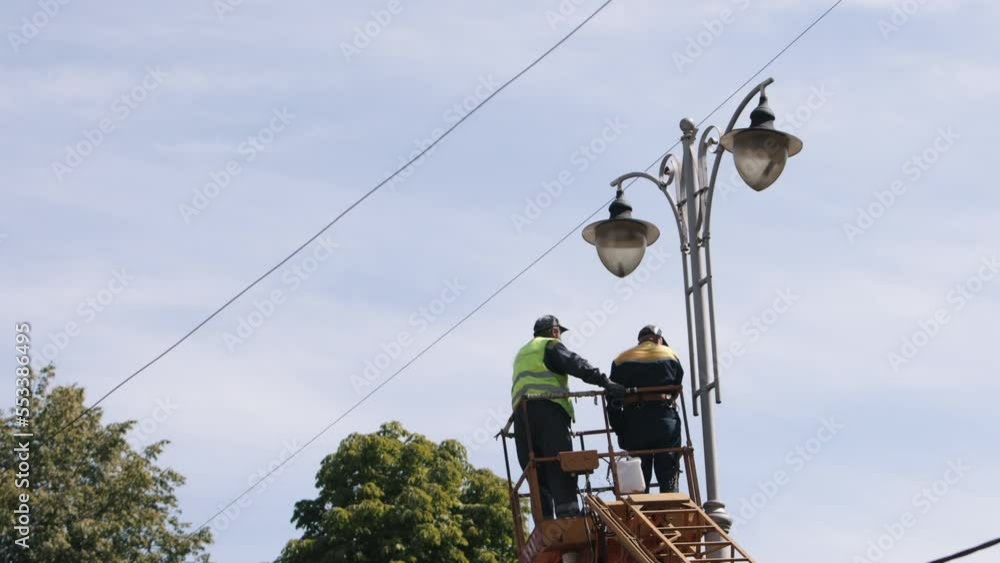 Electric technical, street lamp, during installation. Workmen working ...