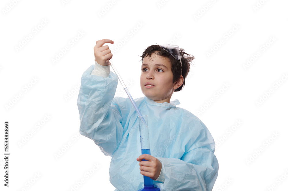 Schoolboy using pipette, dripping few reagents in the flask with ...