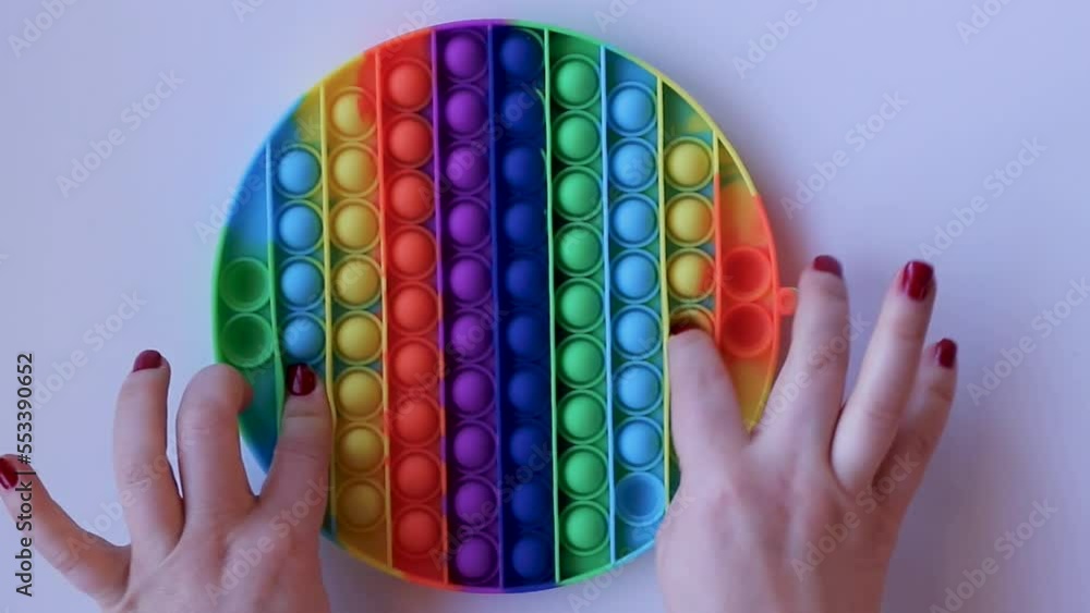 Women hands crumple and play with large round Pop It close-up top view ...