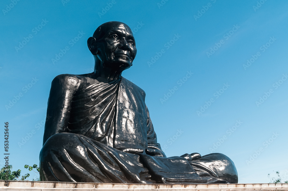 The majestic statue of an enlightened monk in the lotus position at the ...