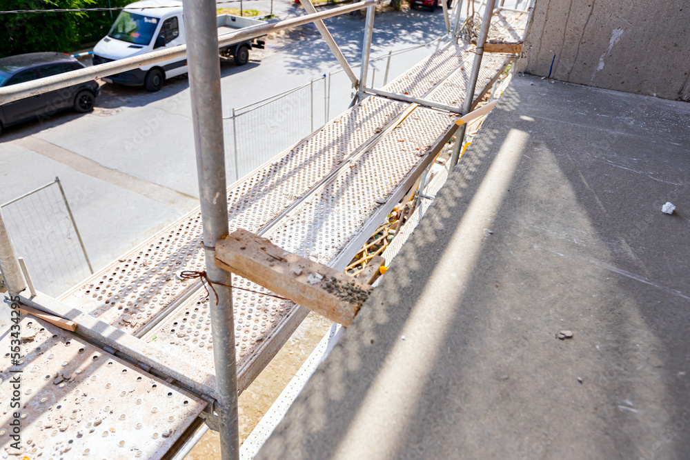 Place of metal perforated scaffold for trampling, installed against ...