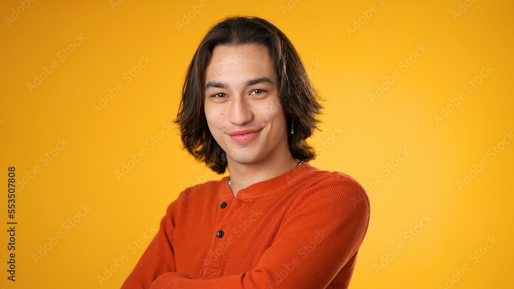Smiling handsome Hispanic Latino young man 20s wearing orange casual ...