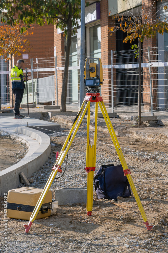 Total station with yellow tachymeter or theodolite with tripod to ...