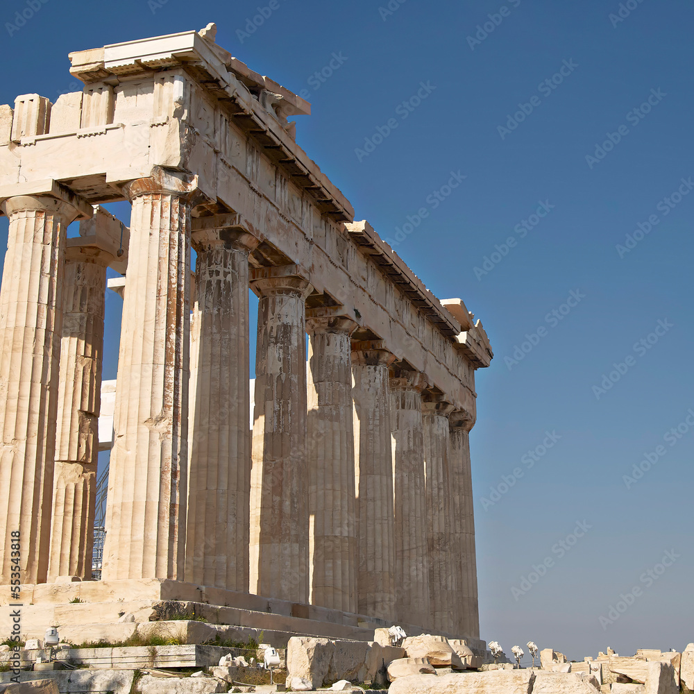 The eastern main front of Parthenon ancient temple under a clear blue sky as a background. A ...