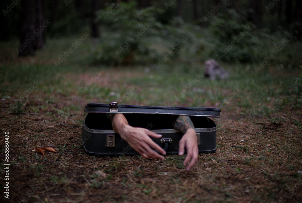 Foto de Surrealistic concept - human hands sticking out of a suitcase ...