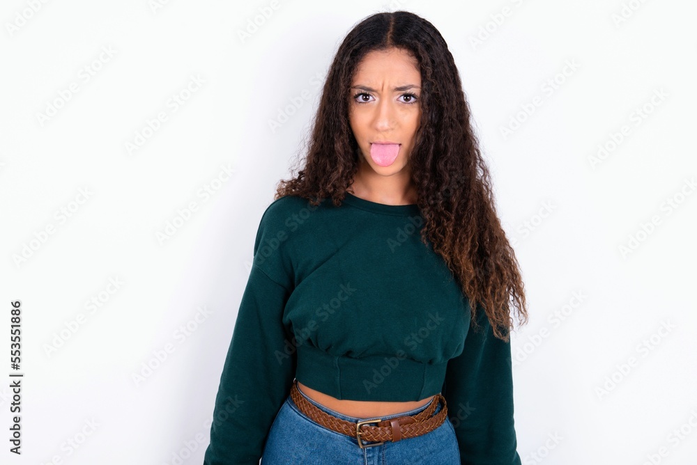 Body language. Disgusted stressed out teen girl with curly hair wearing ...