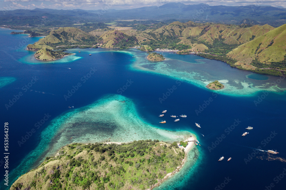 Aerial view of boats moored along the shore of an island in the Komodo ...