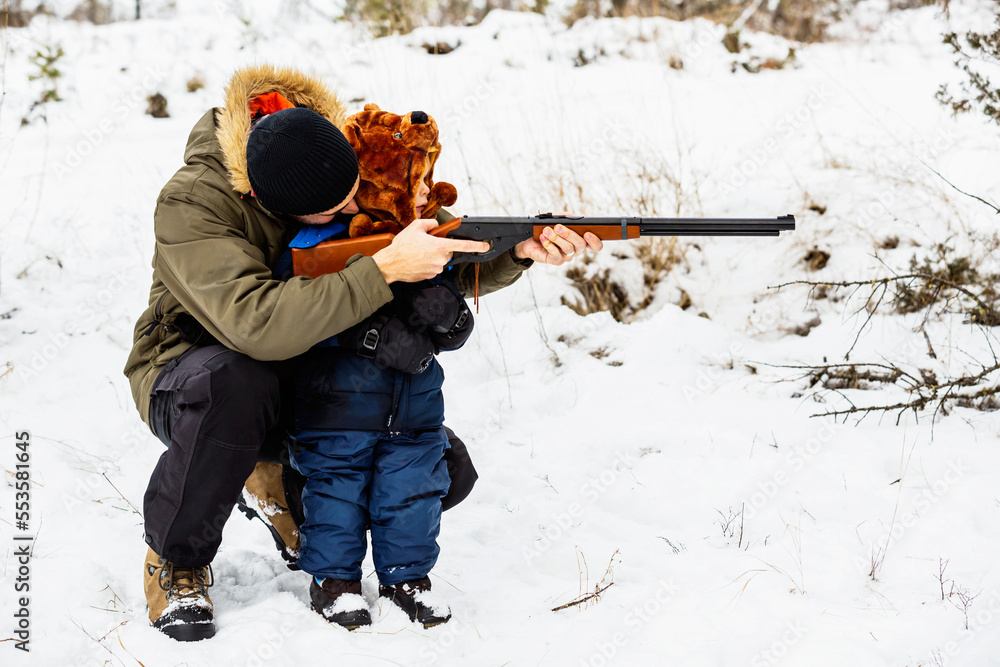 Father Teaching A Young Son How To Shoot A Rifle In Winter At A ...