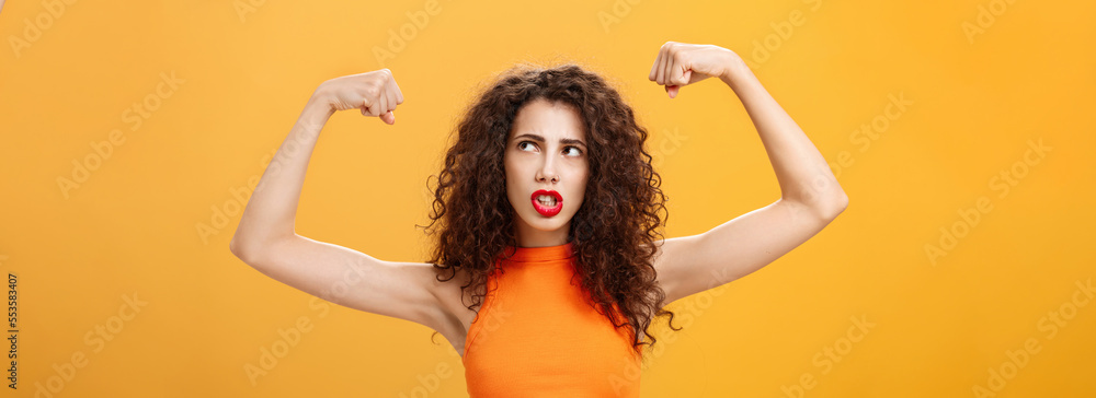 Woman feeling powerful and strong raising hands with clenched fists ...