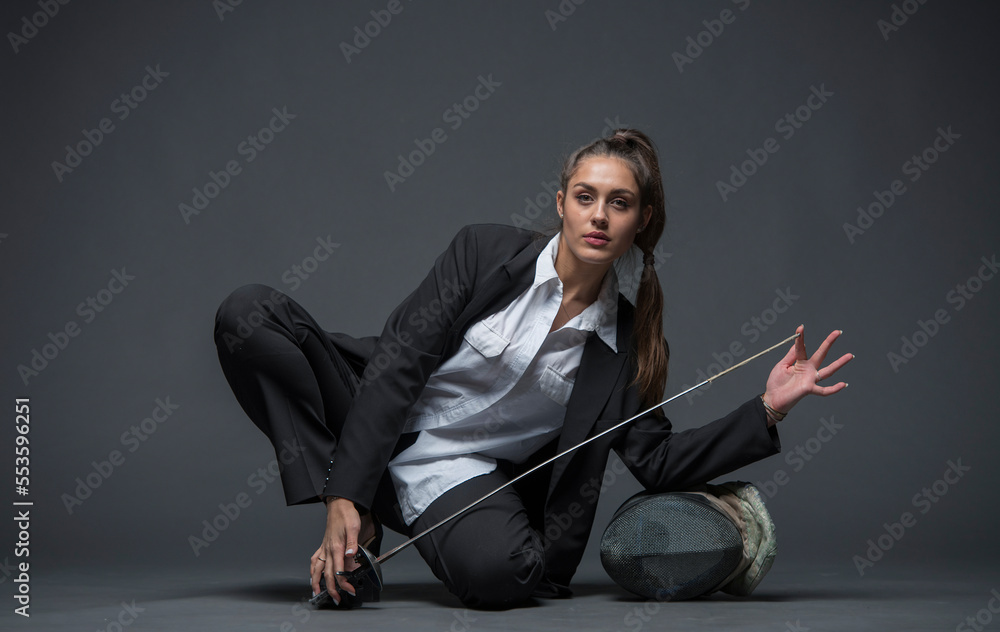 girl with a fencing rapier and a fencing helmet in a black suit Stock ...