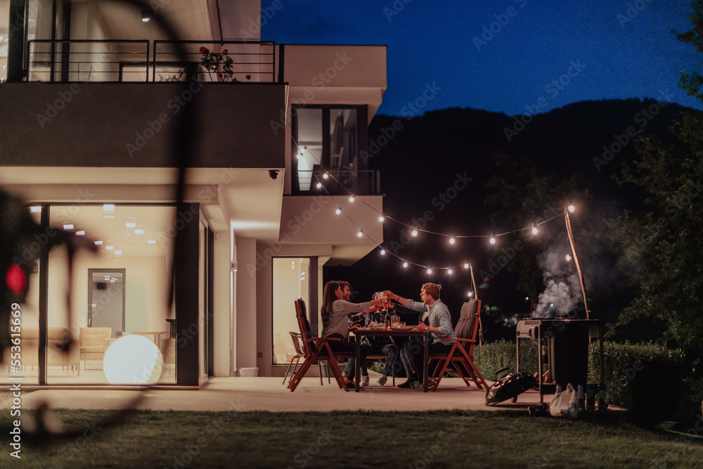 A group of young diverse people having dinner on the terrace of a ...