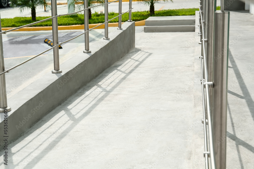 Concrete ramp with shiny metal railings outdoors Stock Photo | Adobe Stock