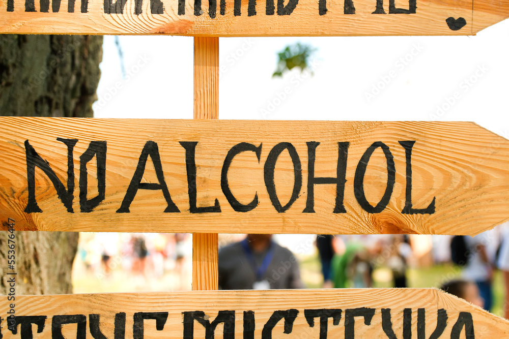 Defocus no alcohol sign is on a wooden board. no alcohol sign over a ...