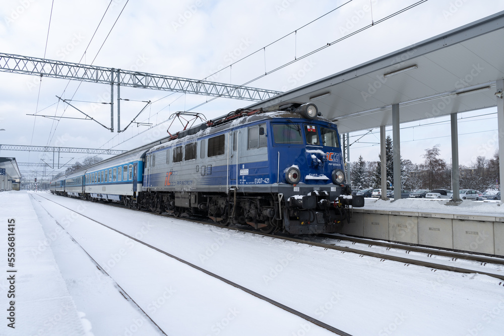 PKP Intercity EU07 electric locomotive with passenger cars. Long-distance express train at ...