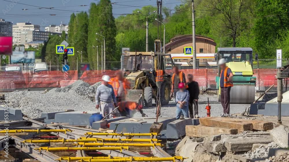 Installing concrete plates and rails by crane at road construction site ...