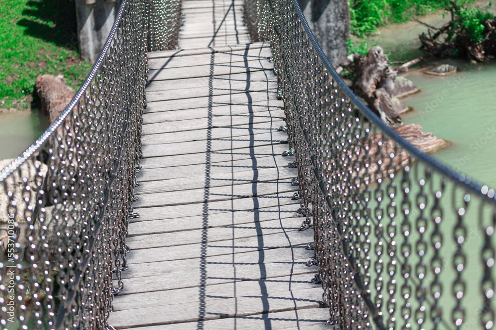 Footbridge over the river . Pedestrian bridge made by chains and wooden ...