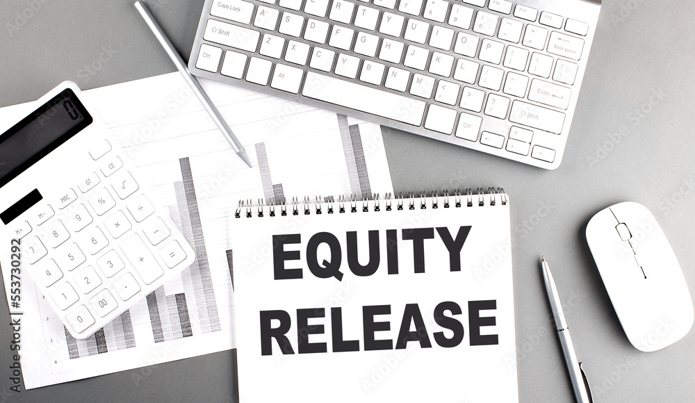 EQUITY RELEASE text written on notebook on grey background with chart ...